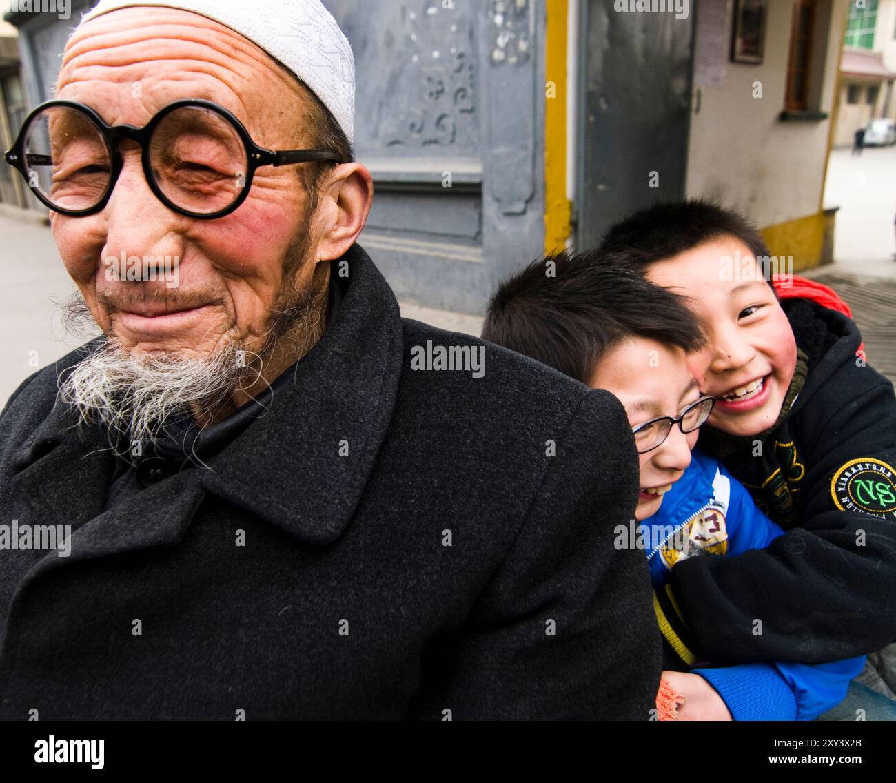 A Hui Muslim man with his grandchildren in Linxia, Gansu, China Stock ...