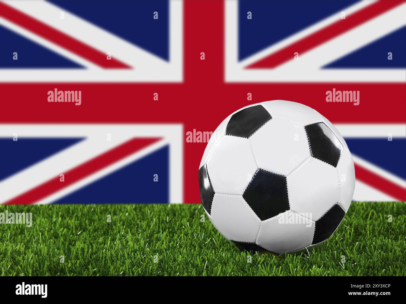 The British flag and soccer ball on the green grass Stock Photo - Alamy