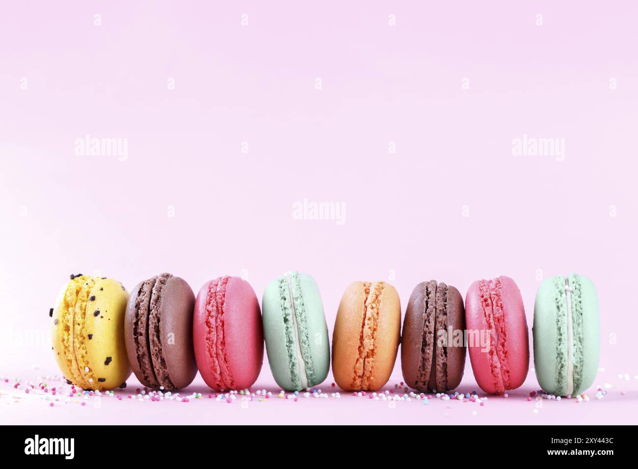 Colorful french macarons on pink background traditioanal desert in ...