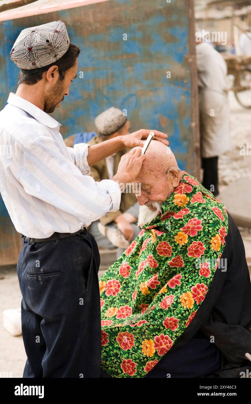 Barbers shaving heads and beards of local Uyghur customers at a local ...