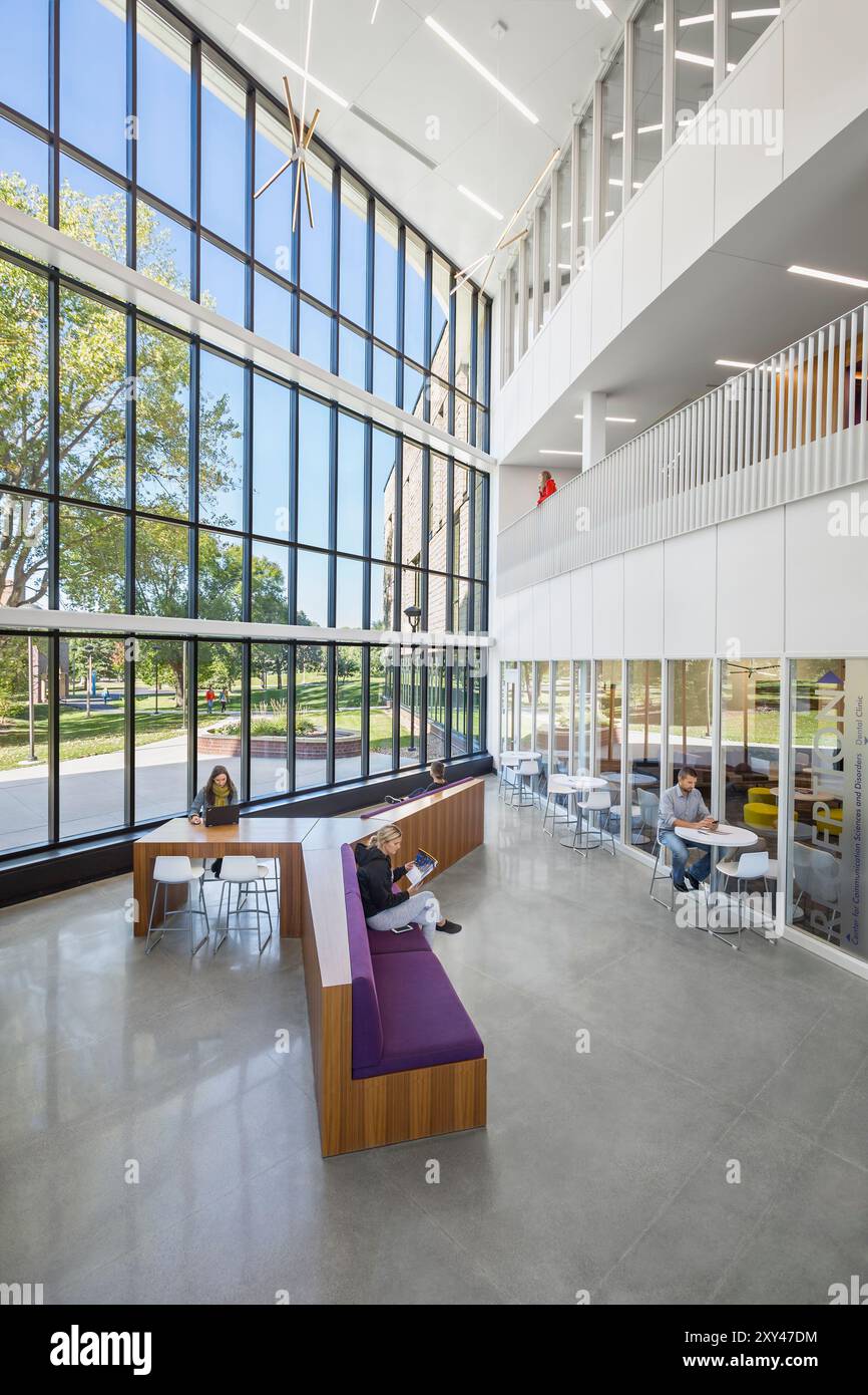 Students hanging out in large atrium of new university building Stock ...