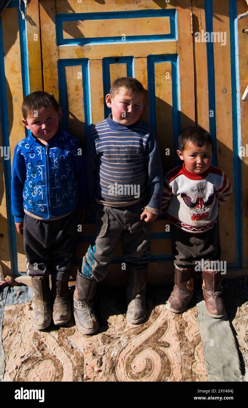 Cute Kazakh children standing outside their yurt in the Altai mountains ...