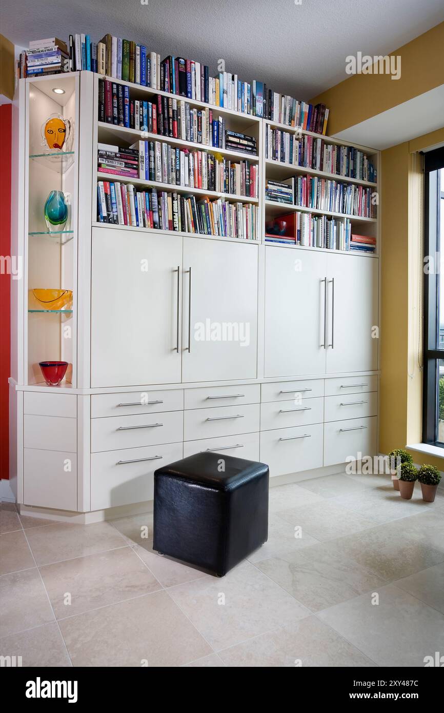 In home office with built in bookshelves and storage and desk area ...