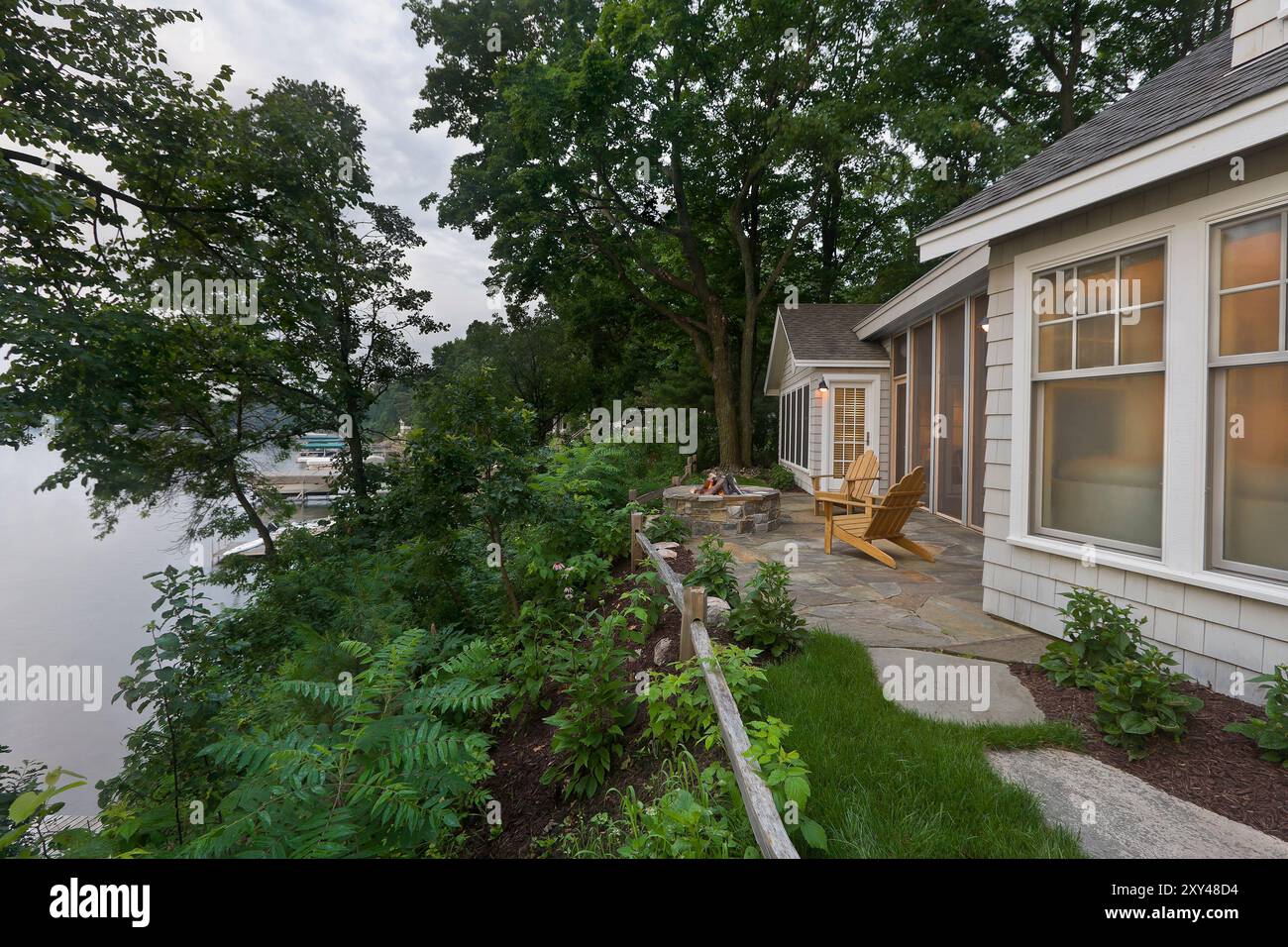 Cottage patio on shoreline overlooking lake Stock Photo - Alamy