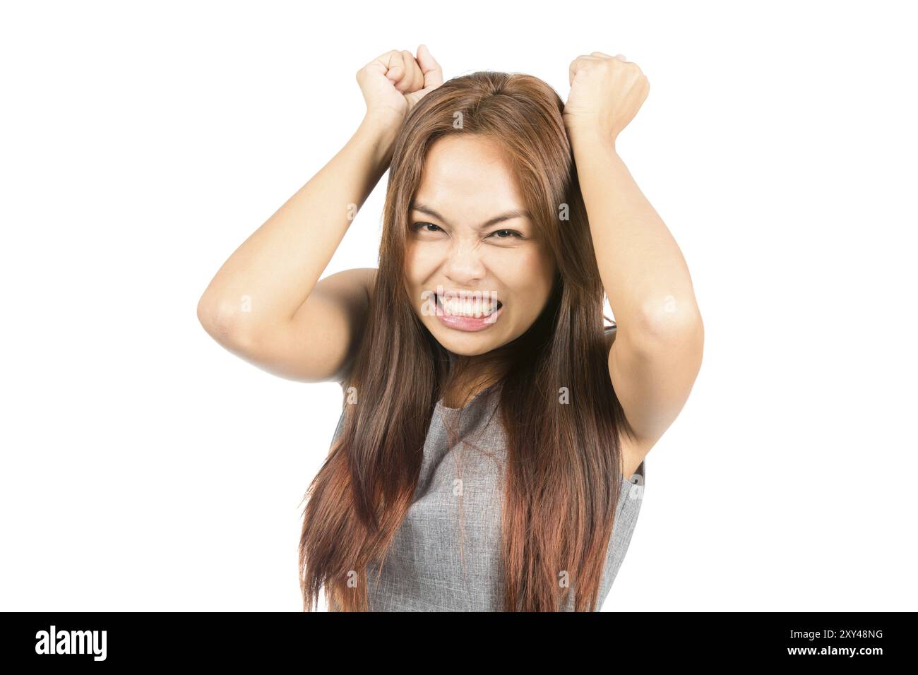 An angry, annoyed Asian girl in gray with light brown hair, gritting ...
