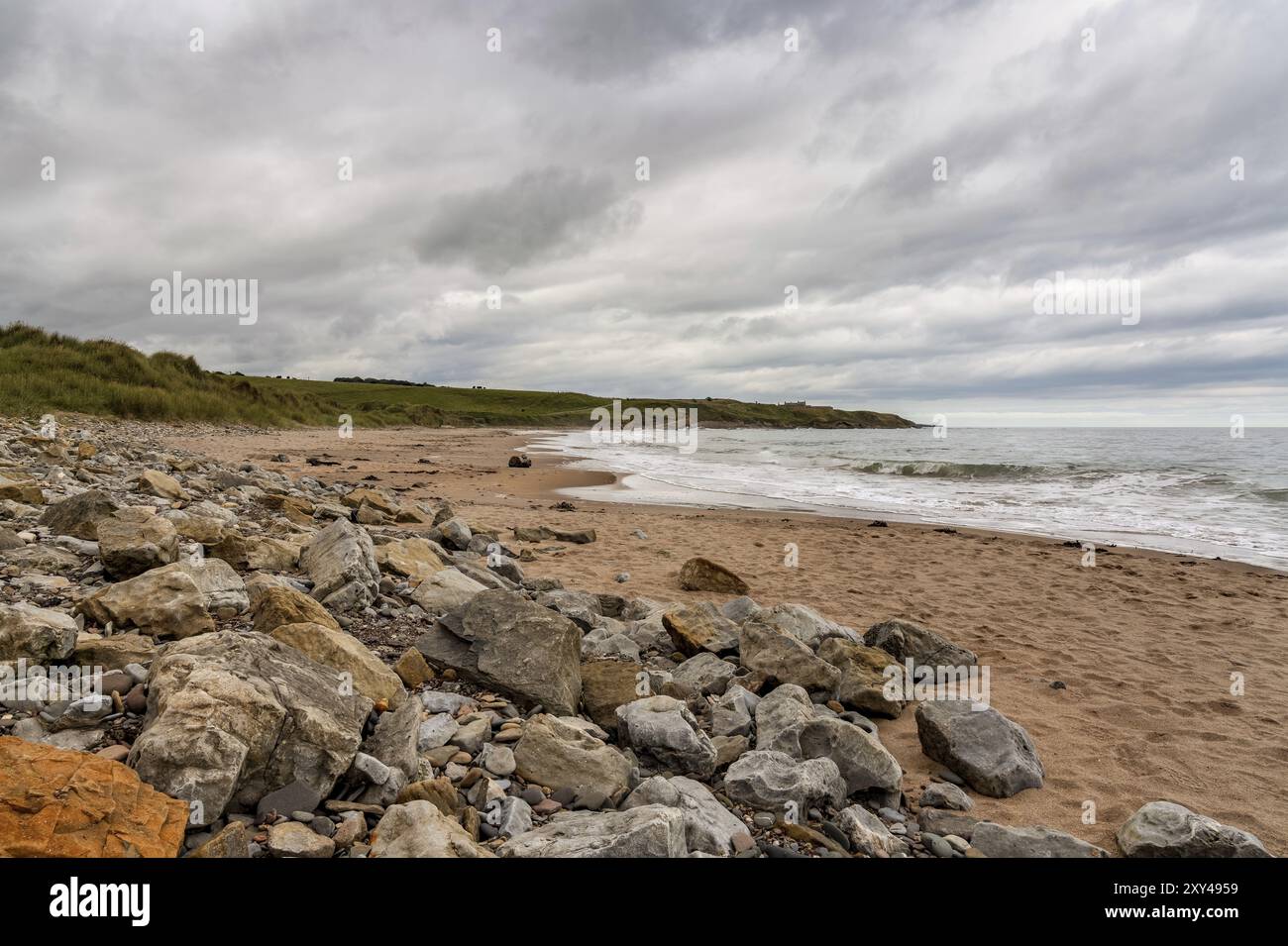 Dark clouds and large stones, seen at Cocklawburn Beach near Berwick ...
