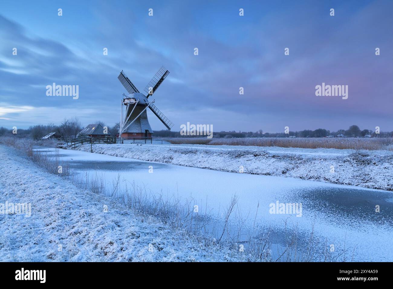 Winter sunrise over windmill in snow, Netherlands Stock Photo - Alamy