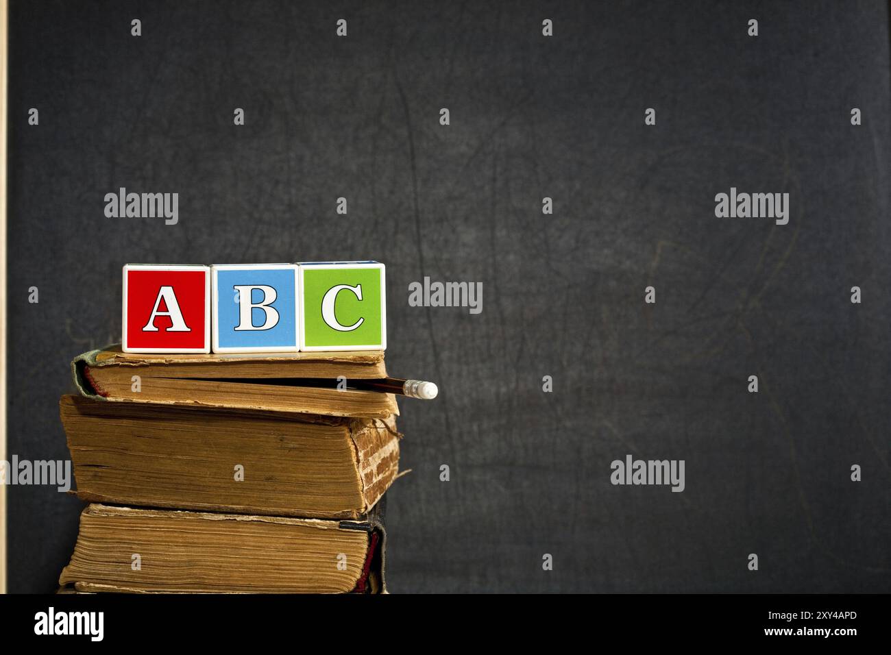 ABC on old textbook against blackboard in class. School concept Stock ...