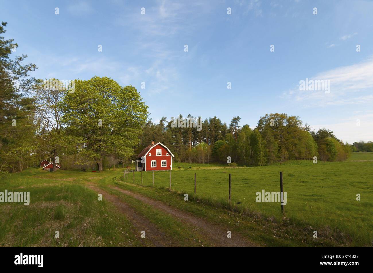 Traditional red-painted wooden house, embedded in a typical southern ...