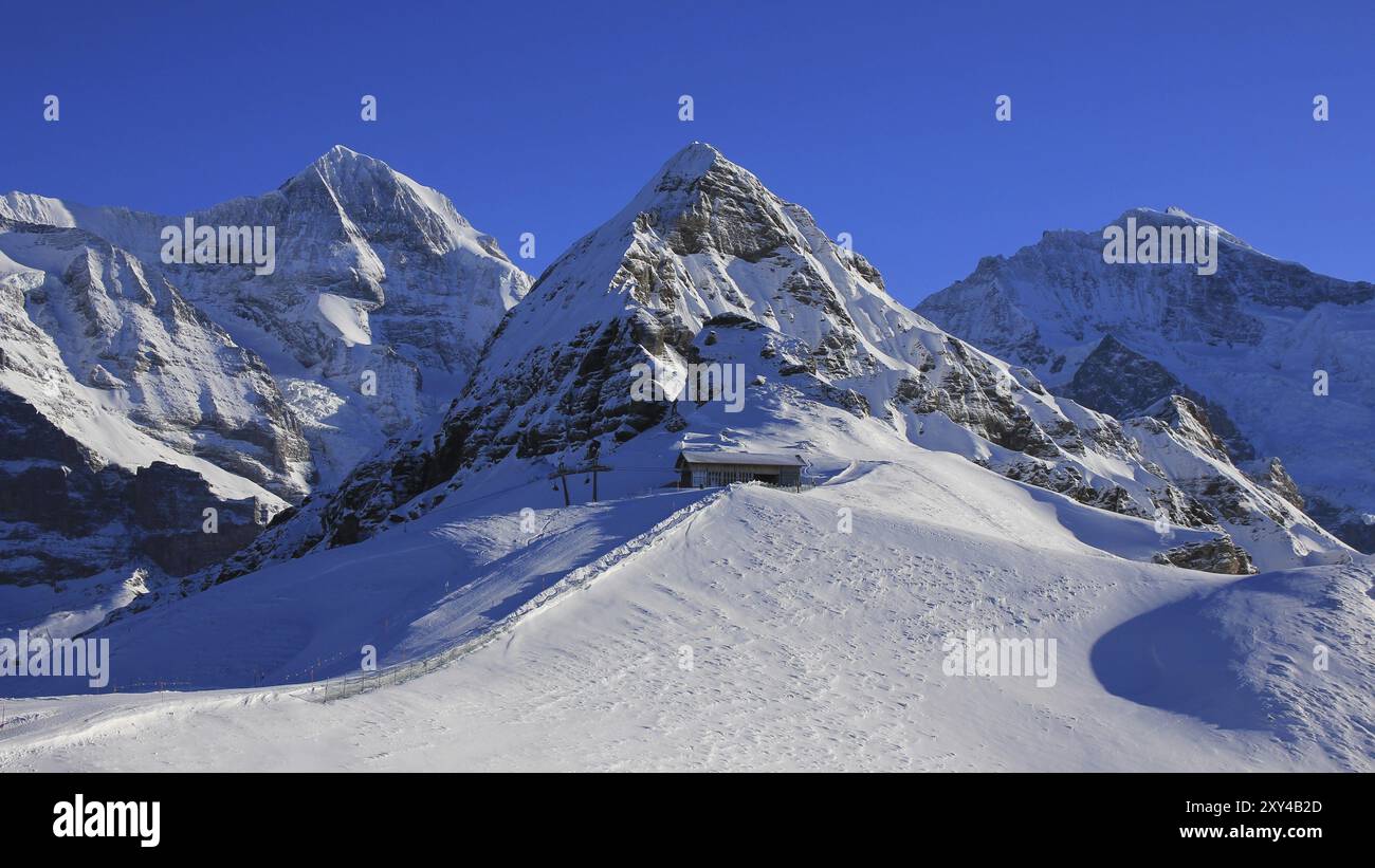 Snow covered mountains Monch, Lauberhorn and Jungfrau. Chair lift and ...