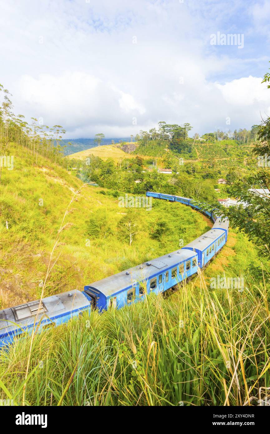 Passenger train moving away on unique circular curving portion of ...