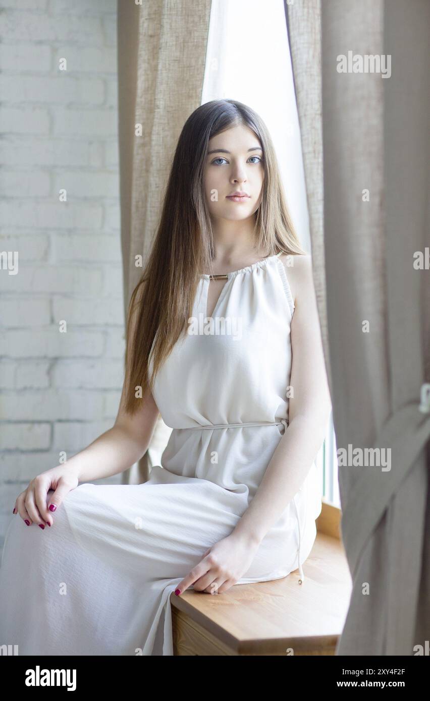 Portrait of a pretty teenage girl sitting on windowsill Stock Photo - Alamy Portrait of a pretty teenage girl sitting on windowsill Stock Photo - Alamy