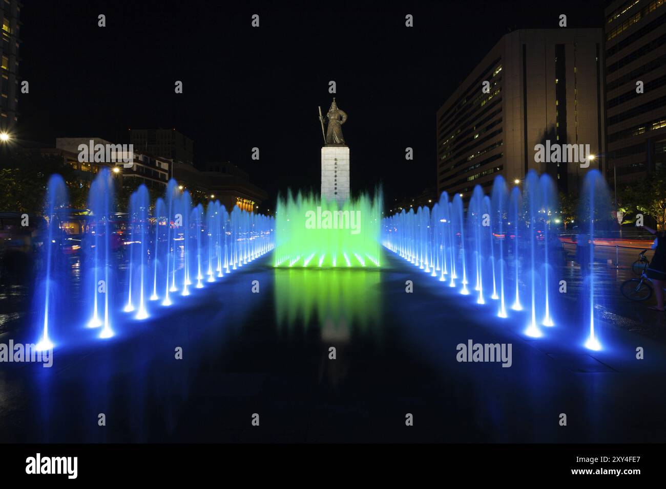The King Sae Jong Dae statue stands among a set of colorfully lit water ...