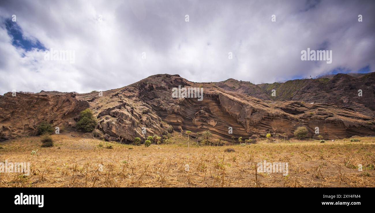 Rocky landscape with dry yellow fields in the foreground Stock Photo ...