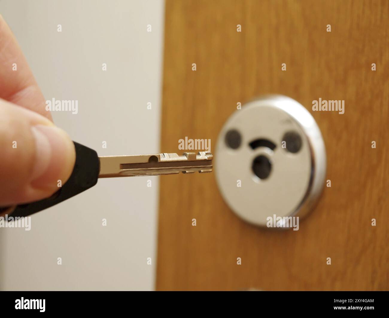 Someone approaching a door with a key Stock Photo - Alamy