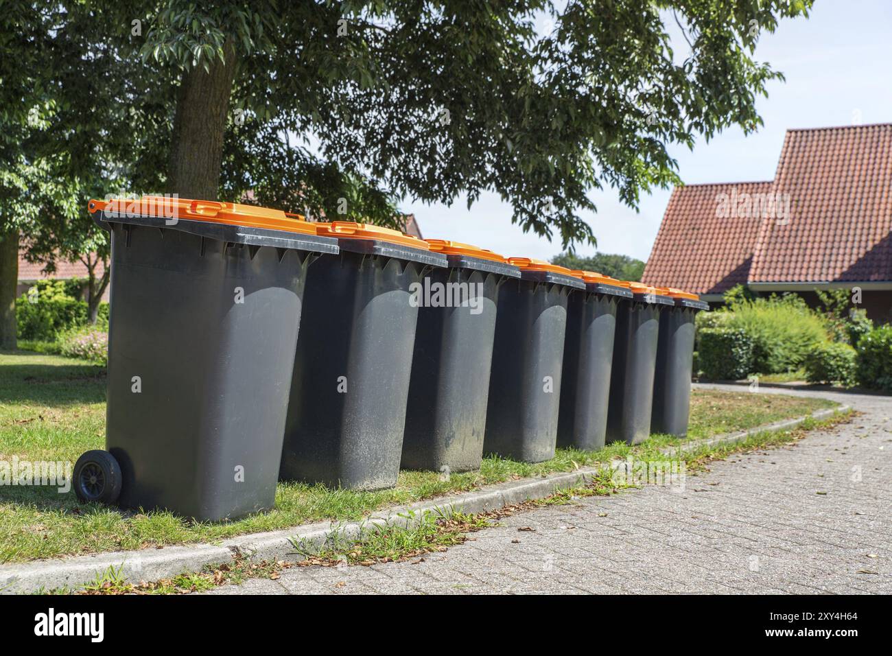 Row of gray waste containers for packaging material along the street ...