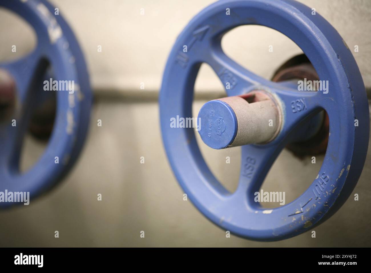 Two blue valve wheels on one machine Stock Photo - Alamy
