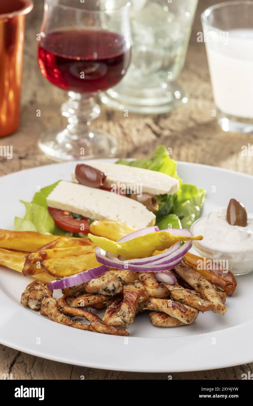 Greek gyros on a plate with chips Stock Photo - Alamy