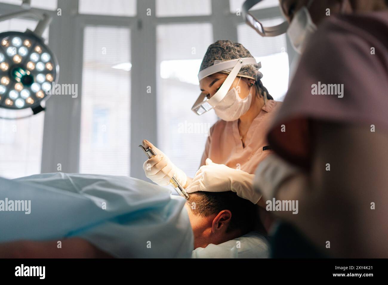 Two female trichologist anesthesiologist performing local needle-free ...