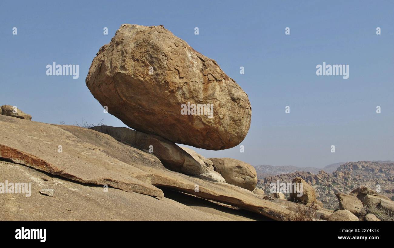 Big balancing granite boulder in Hampi, India. Popular area for ...