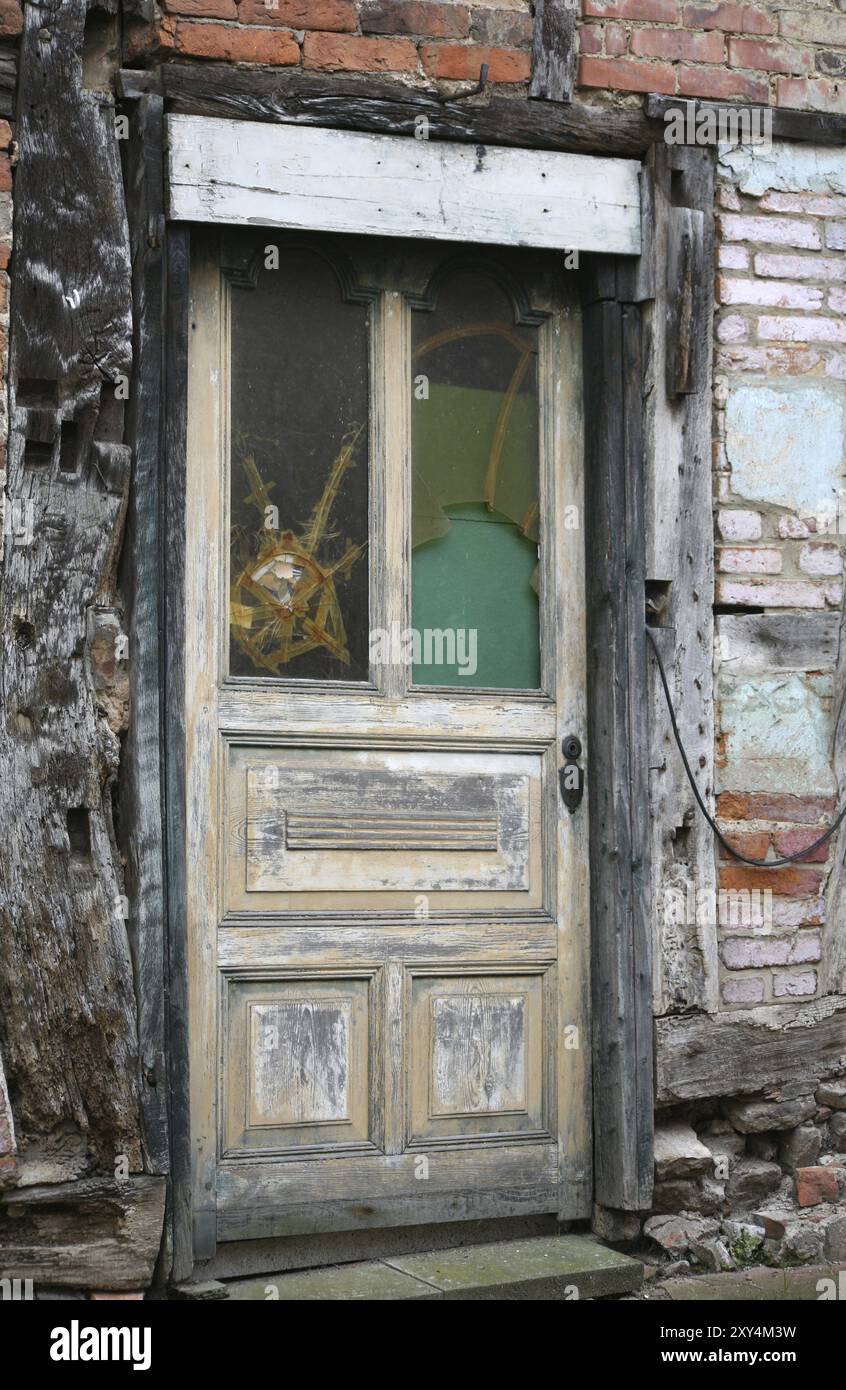 Entrance door to a ruined house Stock Photo - Alamy