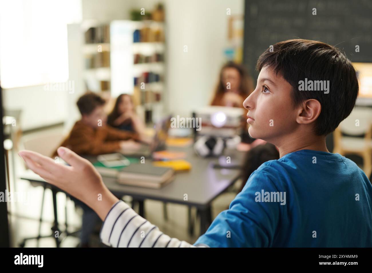 Boy Pointing at Blackboard Stock Photo - Alamy