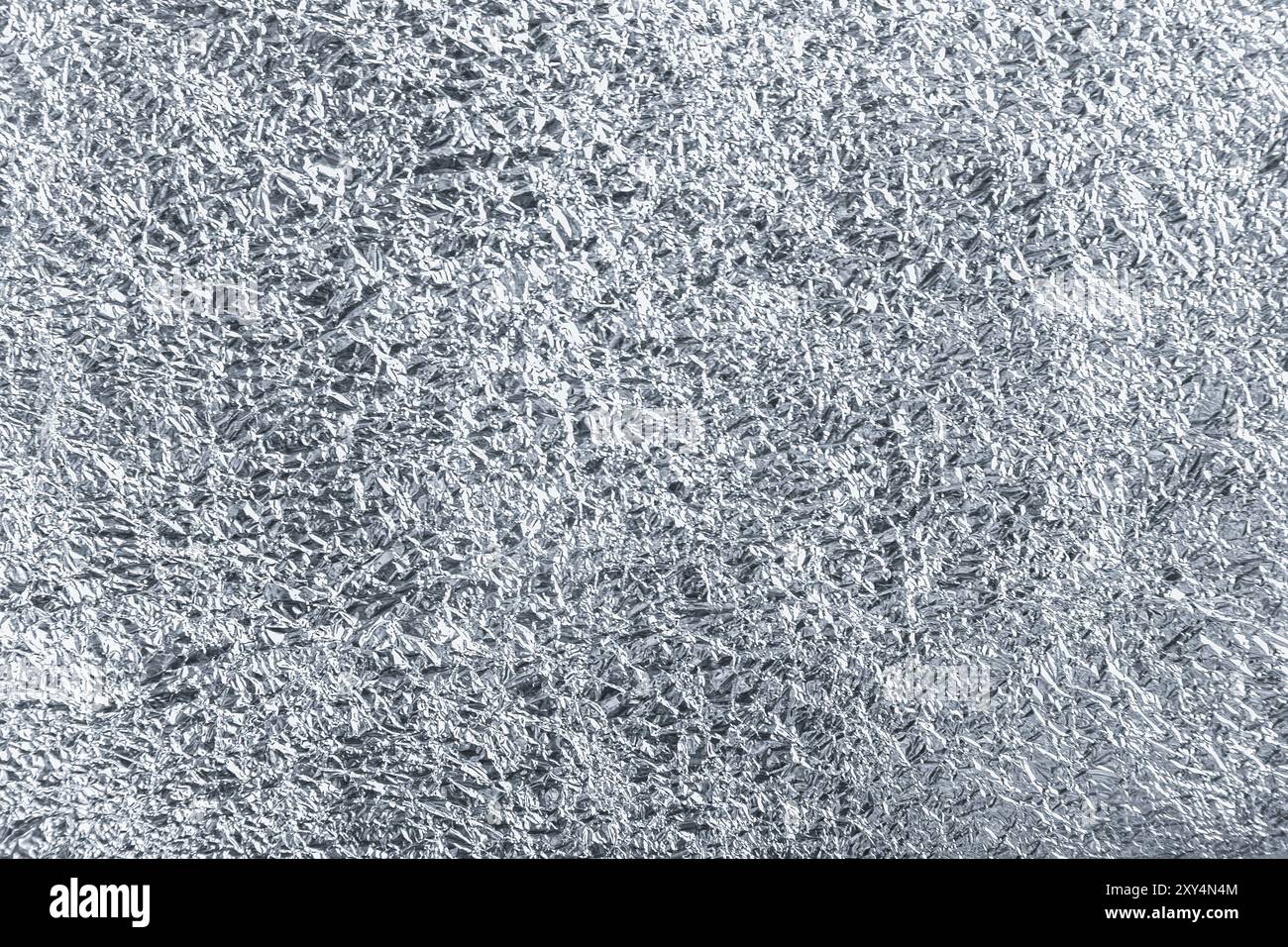 Silver leaf foil background with shiny crumpled uneven surface for texture and background Stock ...