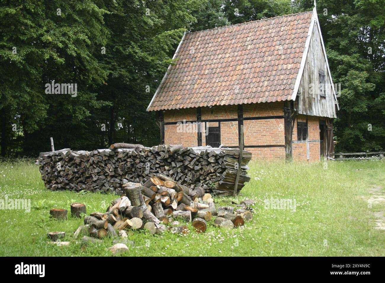 Half-timbered shed with stack of firewood Stock Photo - Alamy
