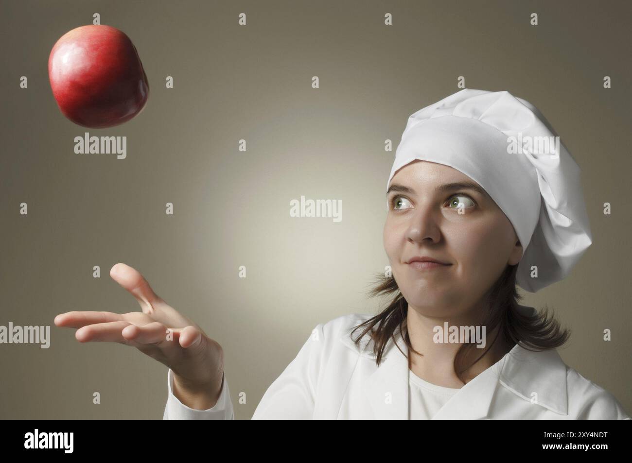 Chef woman throwing a red apple up in the air Stock Photo - Alamy