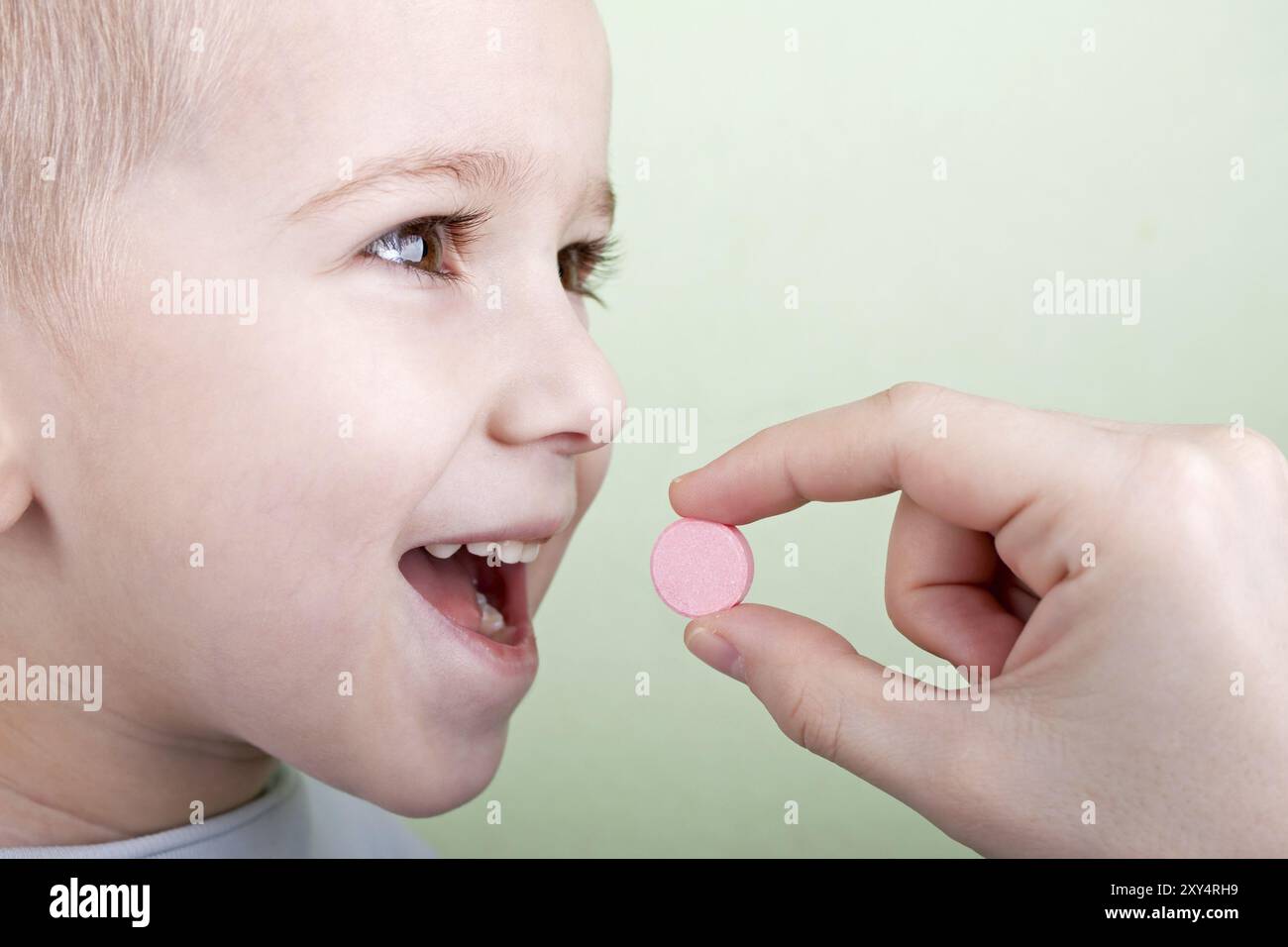 Human hand giving child medicine healthcare pill Stock Photo - Alamy