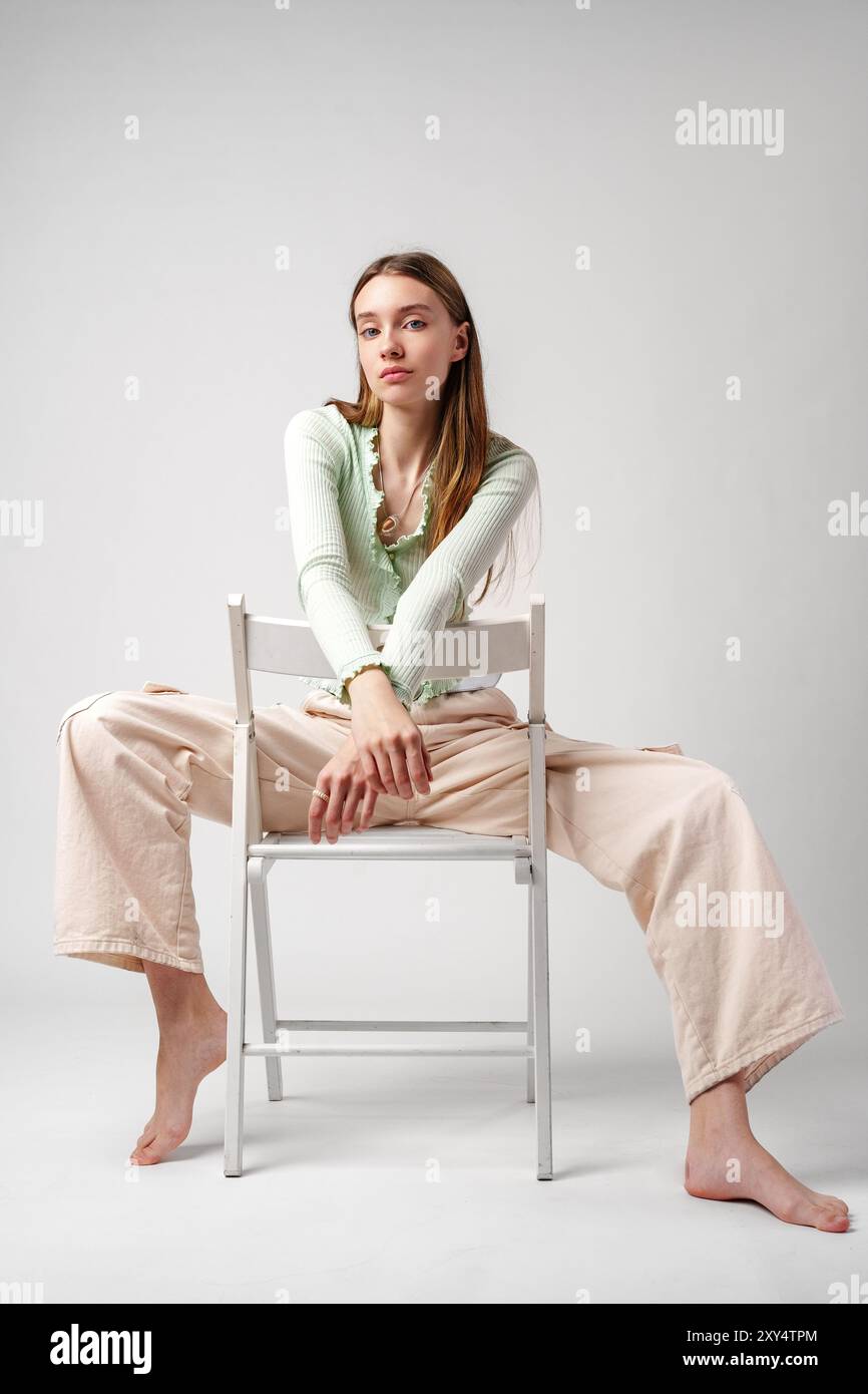 Young Woman Model Sitting and Posing in Studio Stock Photo - Alamy