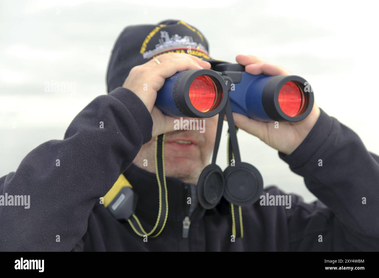 Sailor in side view looking through binoculars Stock Photo - Alamy