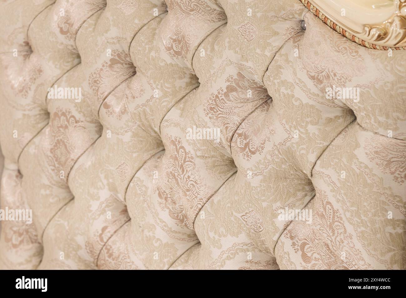 Beige soft tapestry pattern background with symmetrical buttons on the ...