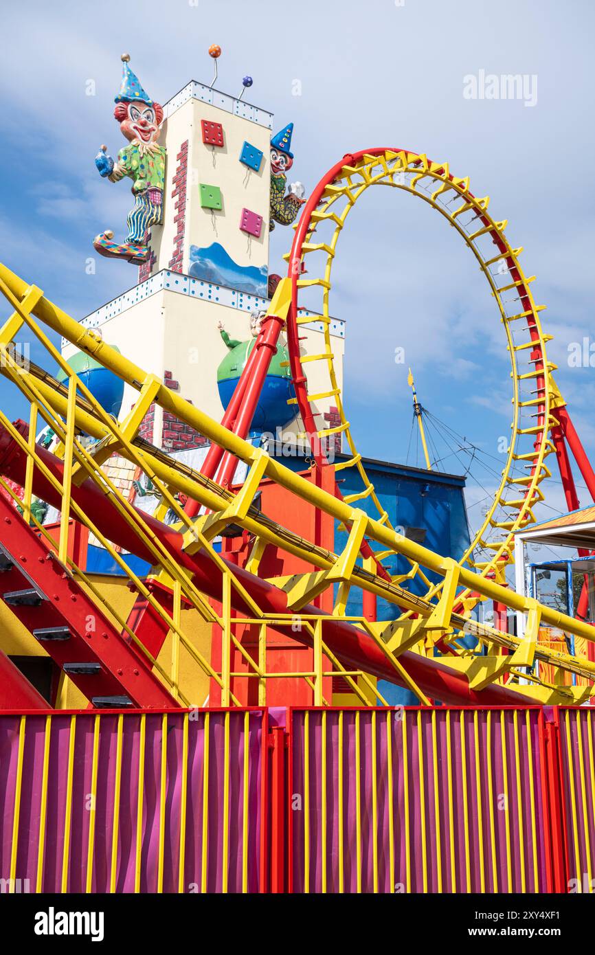 Colorful roller coaster and backdrops in the Prater of Vienna under a ...