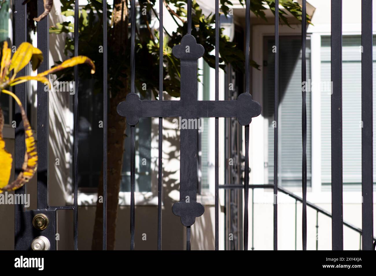 black wrought iron gate with cross design Stock Photo - Alamy
