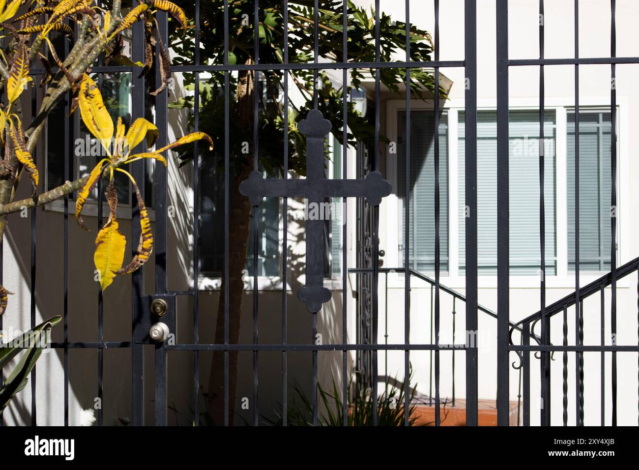 black wrought iron gate with cross design Stock Photo - Alamy