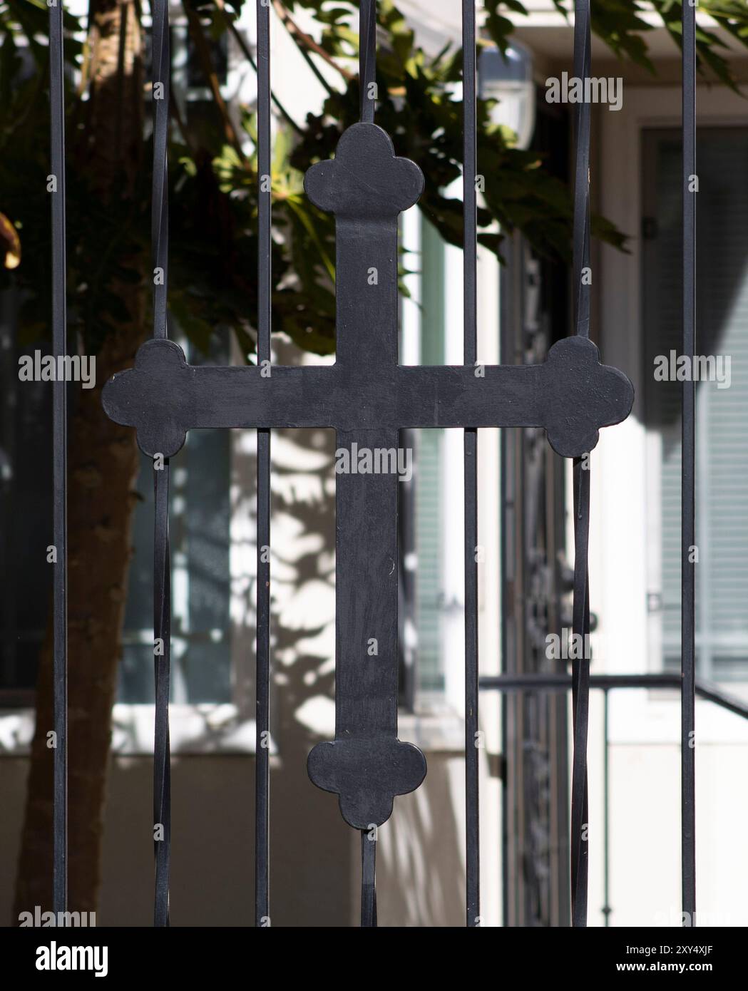 black wrought iron gate with cross design Stock Photo - Alamy