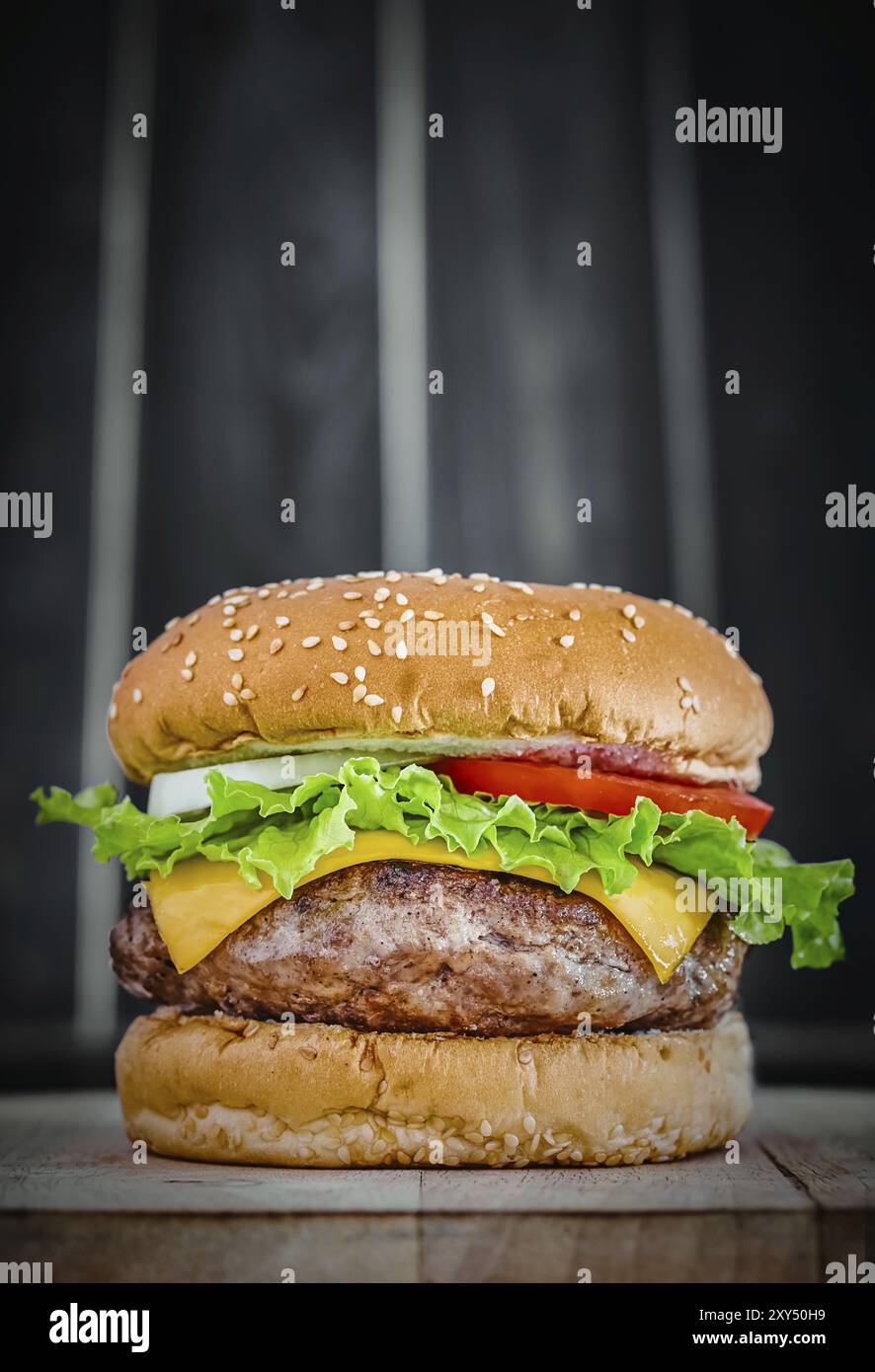 Tasty grilled beef Burger on wood background Stock Photo - Alamy