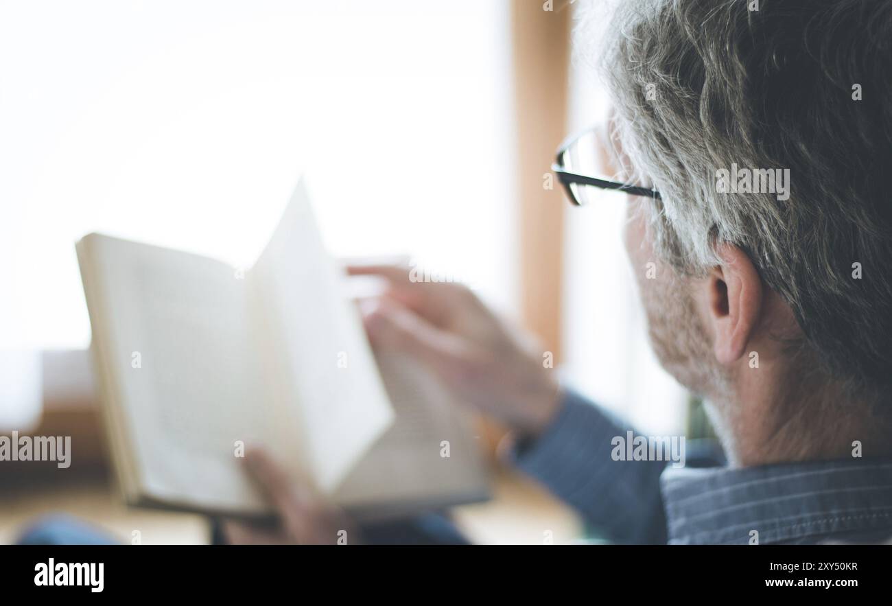 Cut out picture of a senior man who is reading a book at home Stock ...