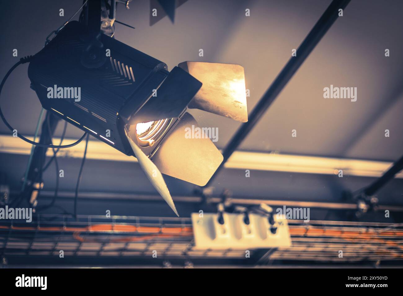Professional orange studio spotlight hanging on the ceiling Stock Photo ...