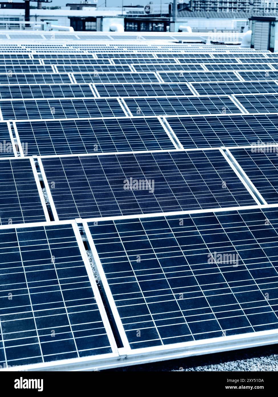 Array of solar panels in rows on a roof of a building in a city Stock ...