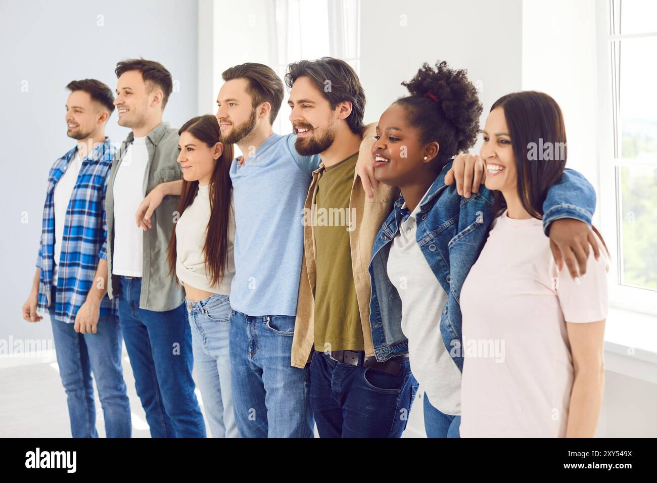 Happy Group Of Young People Embracing Each Other Stock Photo - Alamy