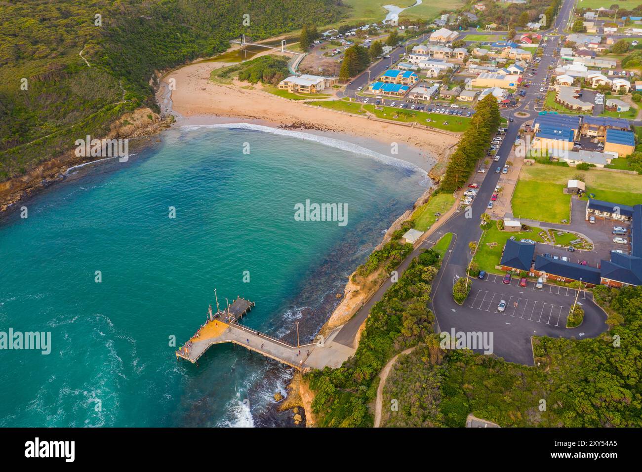 Aerial view of a small coastal township behind a sandy beach and ...