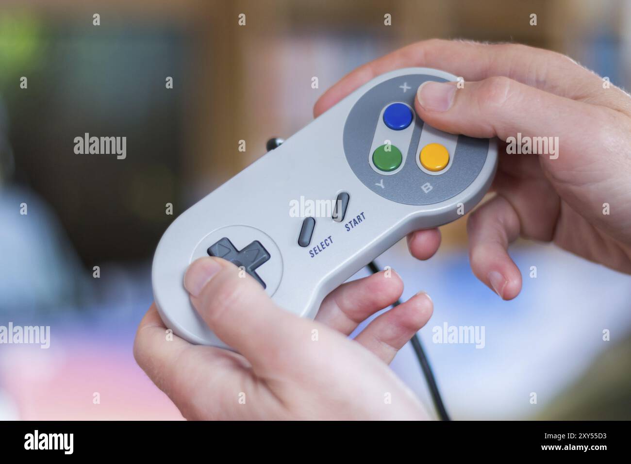 Playing a retro video game, game controller, blurry background Stock ...