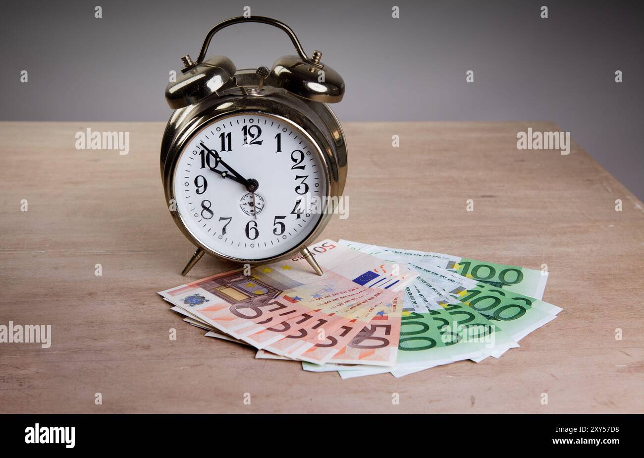 Euro notes with old mechanical clock, time is money Stock Photo - Alamy