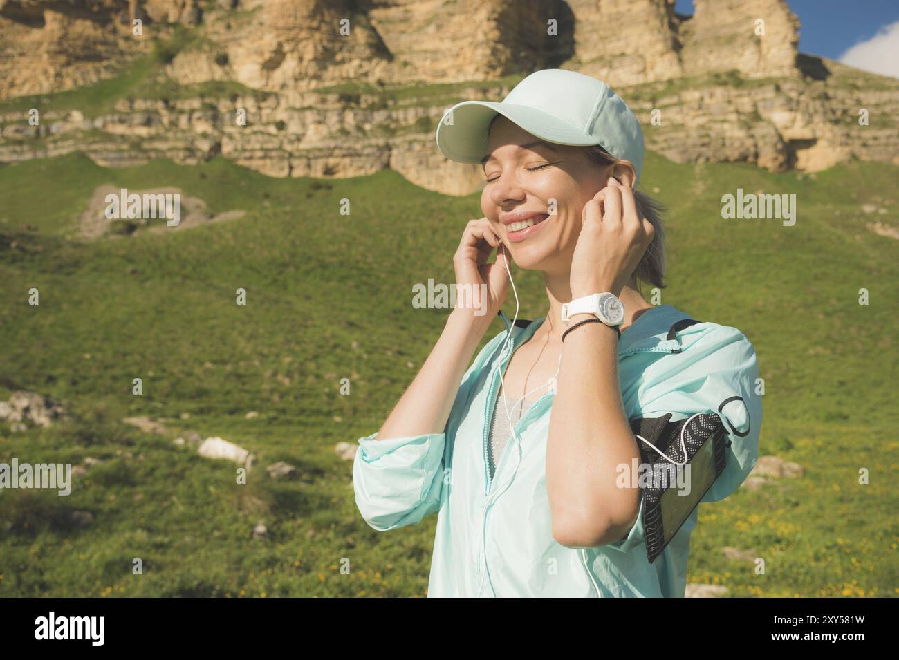 Fitness runner woman closing his eyes listening to music on the nature ...