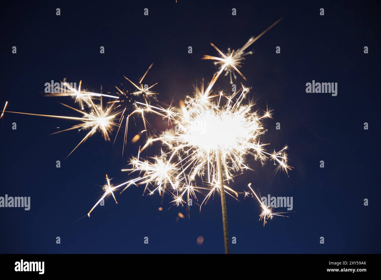 Christmas sparkler on black background. Sparks Stock Photo - Alamy