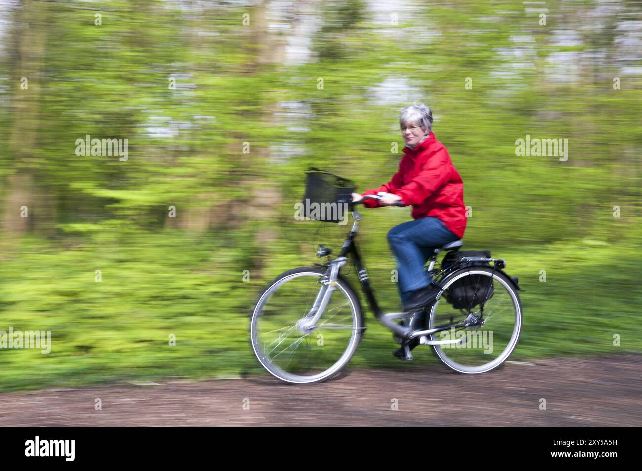 Older woman with glasses bike riding hi-res stock photography and ...