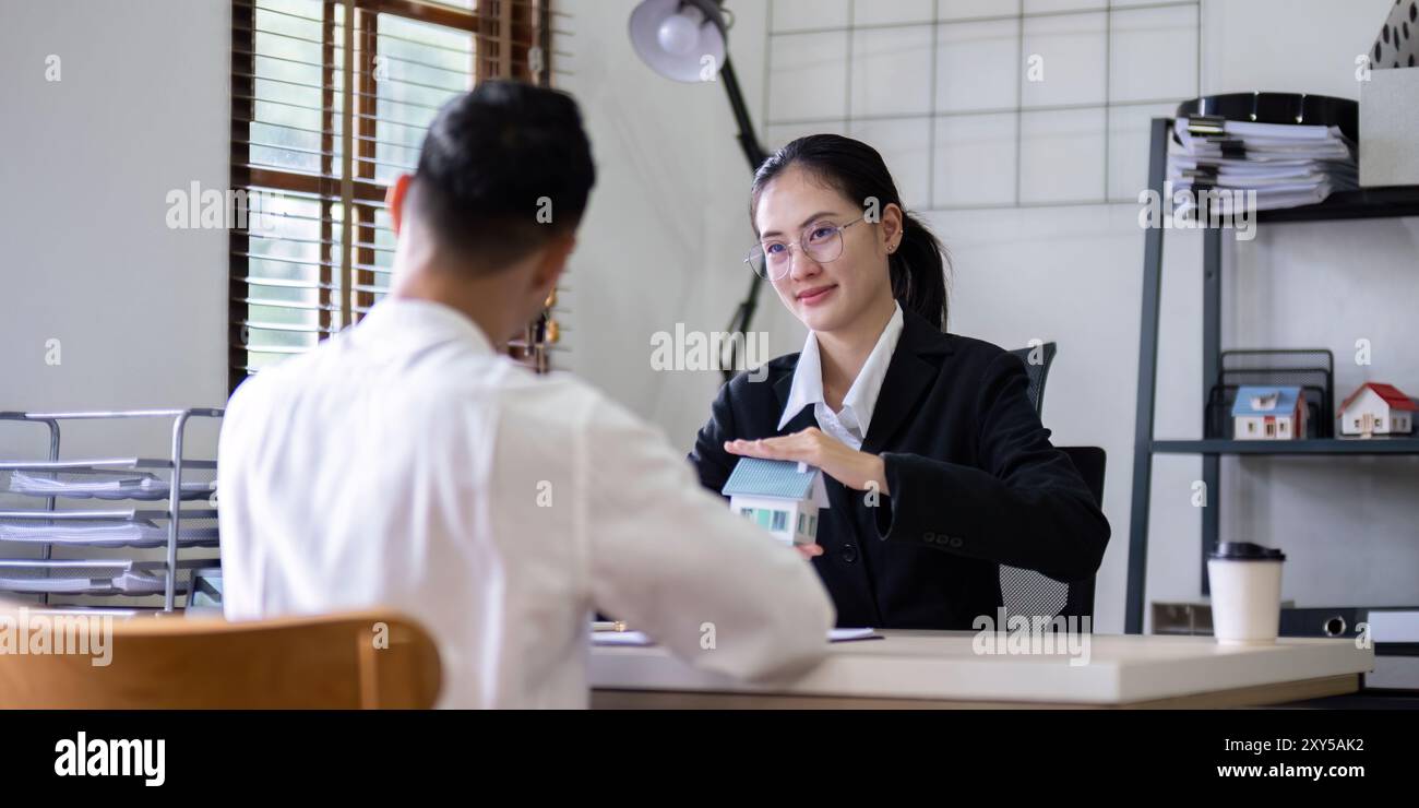Real Estate Agent Discussing Property Details with Potential Buyer ...