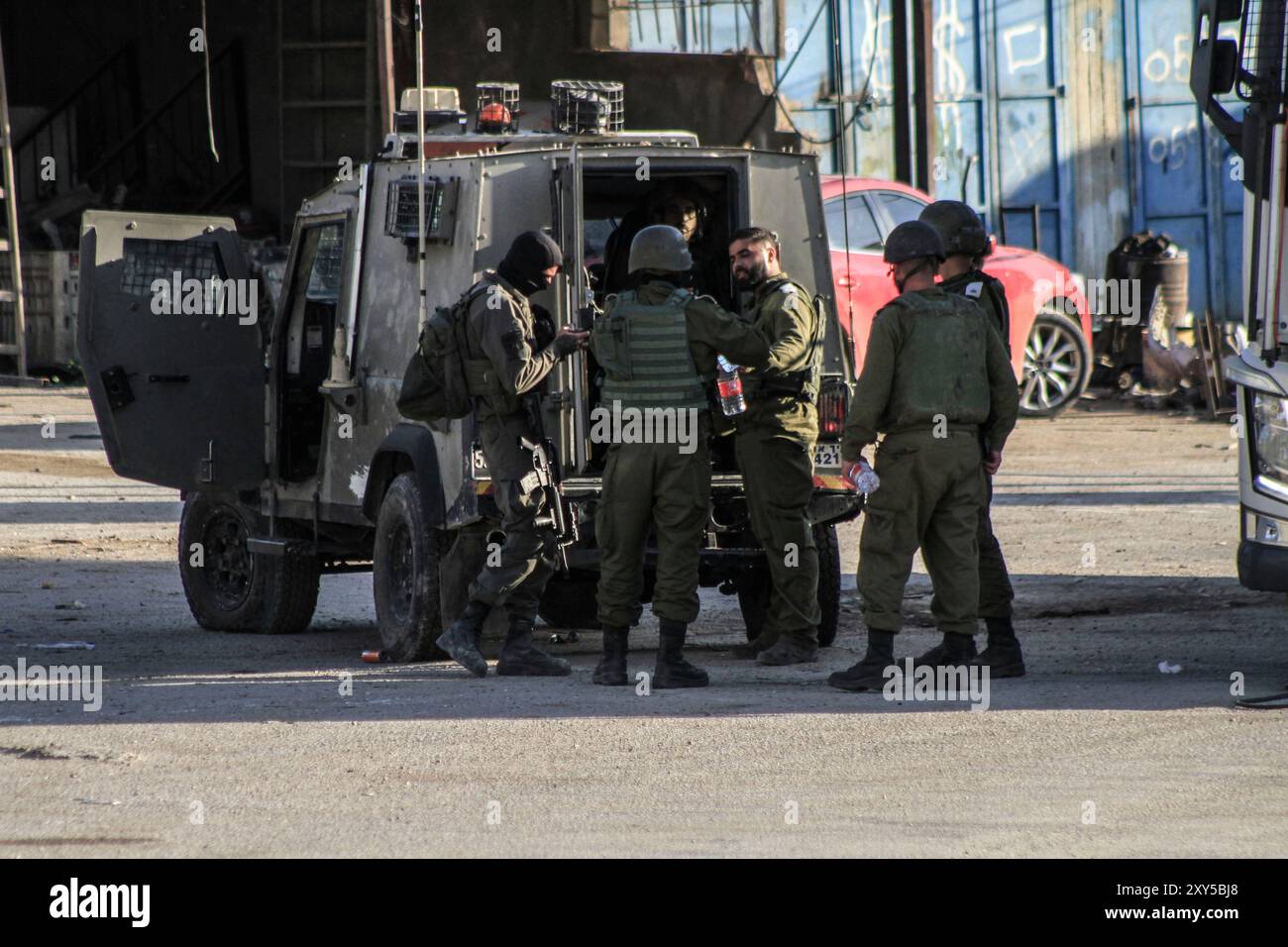 An Israeli infantry force is seen in the center of the Far'a refugee ...